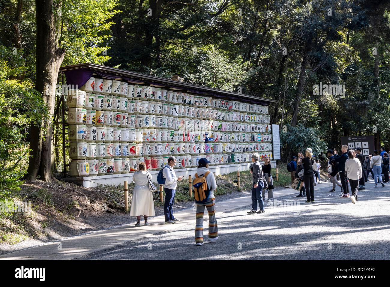 Tokyo, Japan - March 14, 2025: Barrels of sake wrapped in straw offered ...