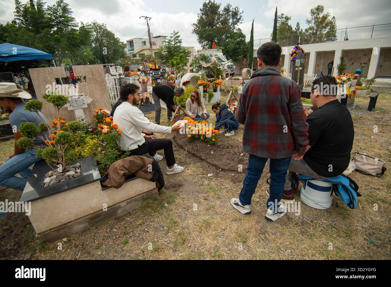 Persons attend the Municipal Cemetery to keep vigil and decorate the ...