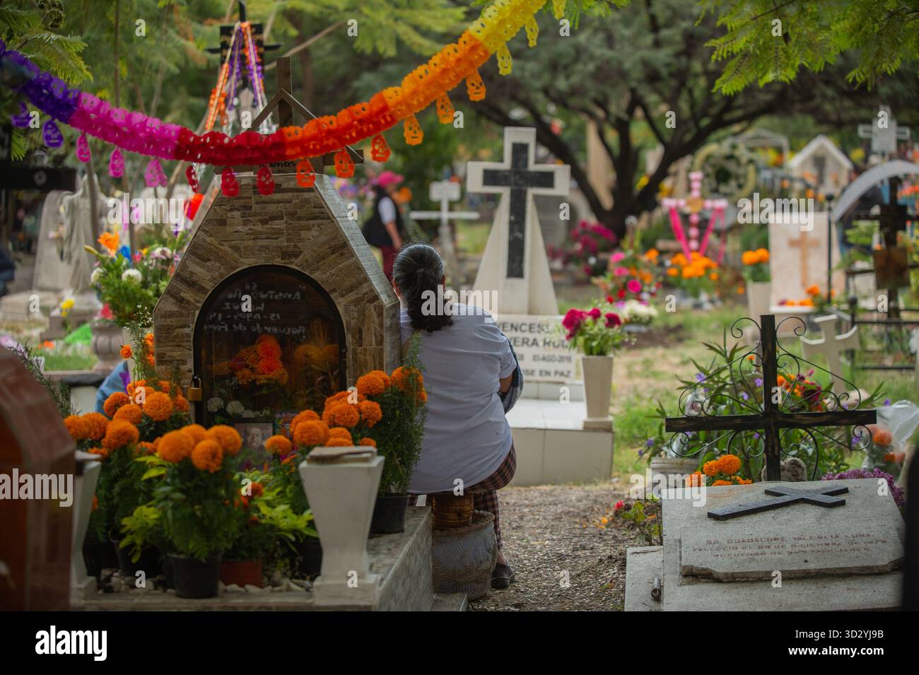 Persons attend the Municipal Cemetery to keep vigil and decorate the ...
