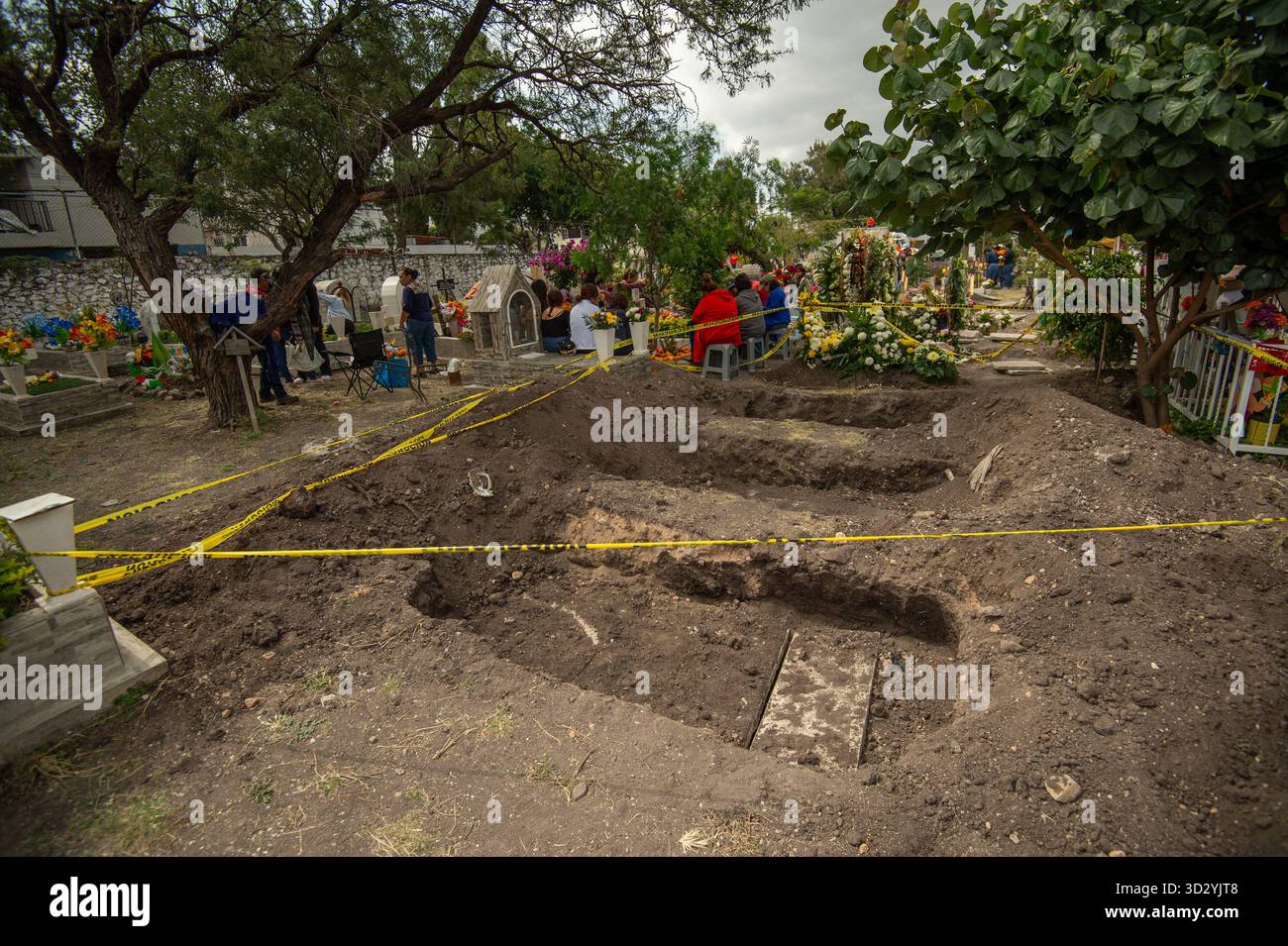 Persons attend the Municipal Cemetery to keep vigil and decorate the ...