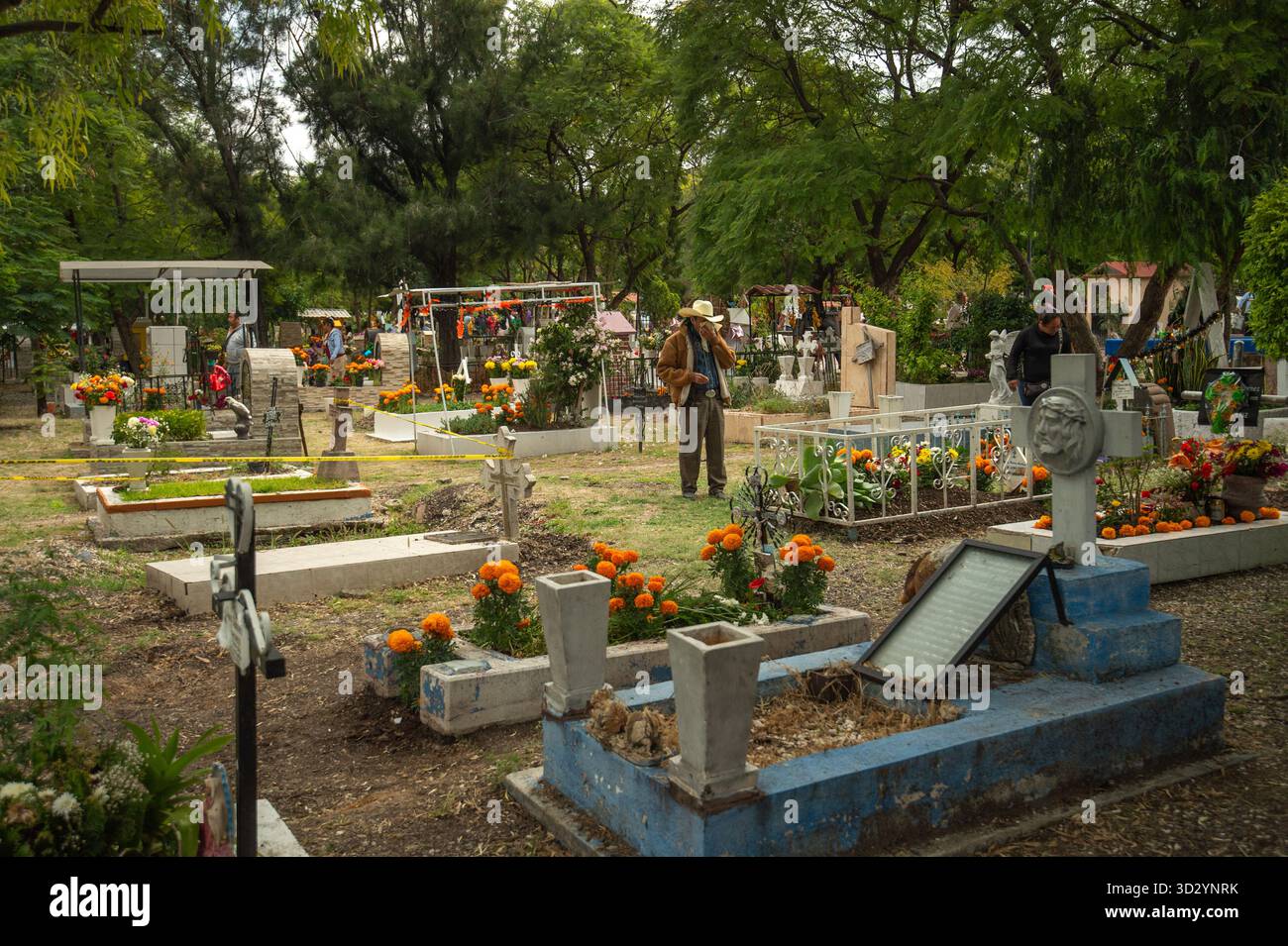 Persons attend the Municipal Cemetery to keep vigil and decorate the ...