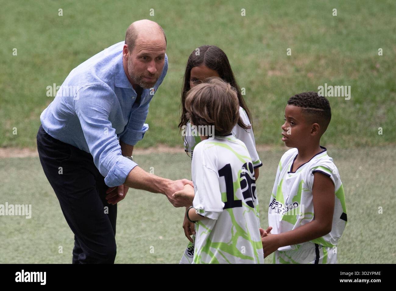 Britain's Prince William shakes hands with a child during a visit to ...