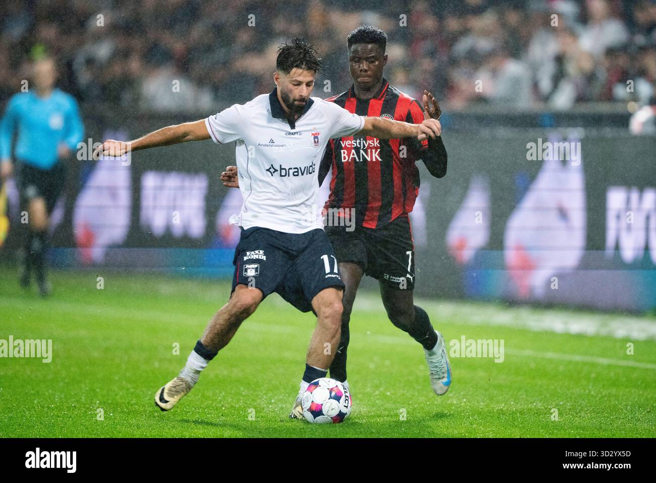 AGF's Kevin Yakob in battle with FC Midtjylland's Dju Franculino during ...