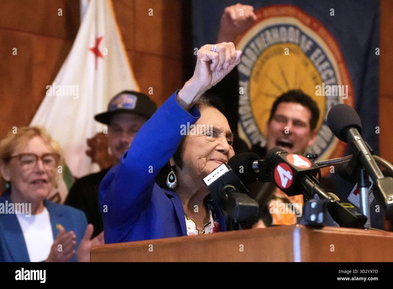 Dolores Huerta, co-founder of United Farm Workers, foreground, speaks ...