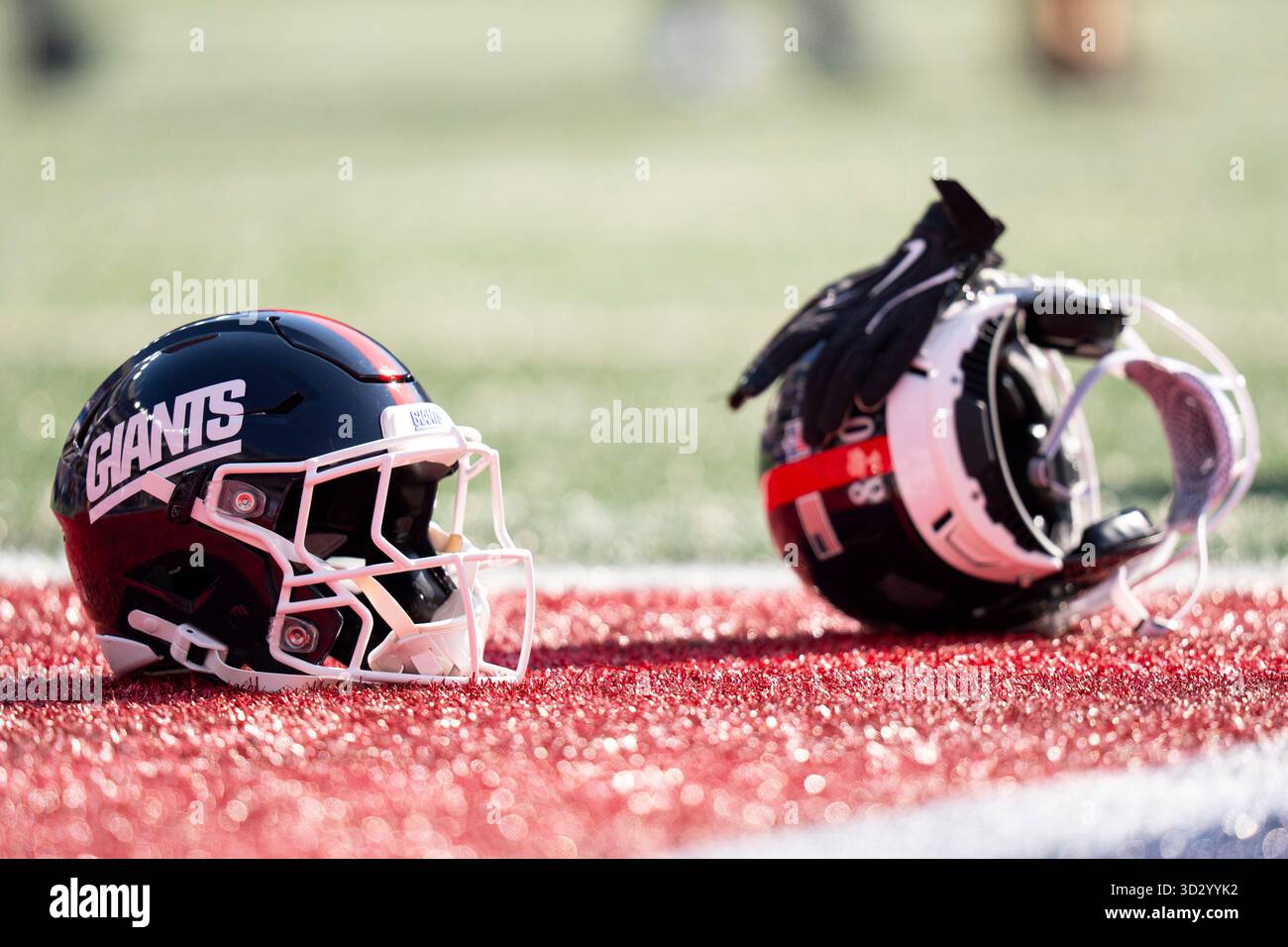 New York Giants helmets sit on the field prior to an NFL football game ...