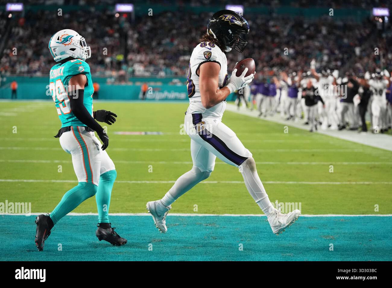 Baltimore Ravens tight end Charlie Kolar, right, scores a touchdown in ...