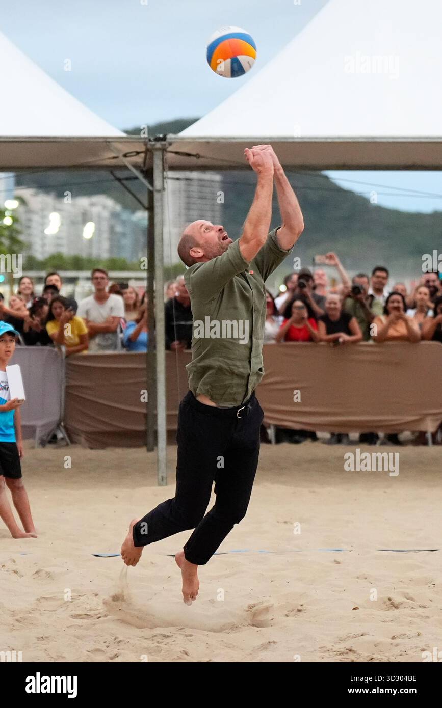 The Prince of Wales takes part in a game of volleyball with players ...