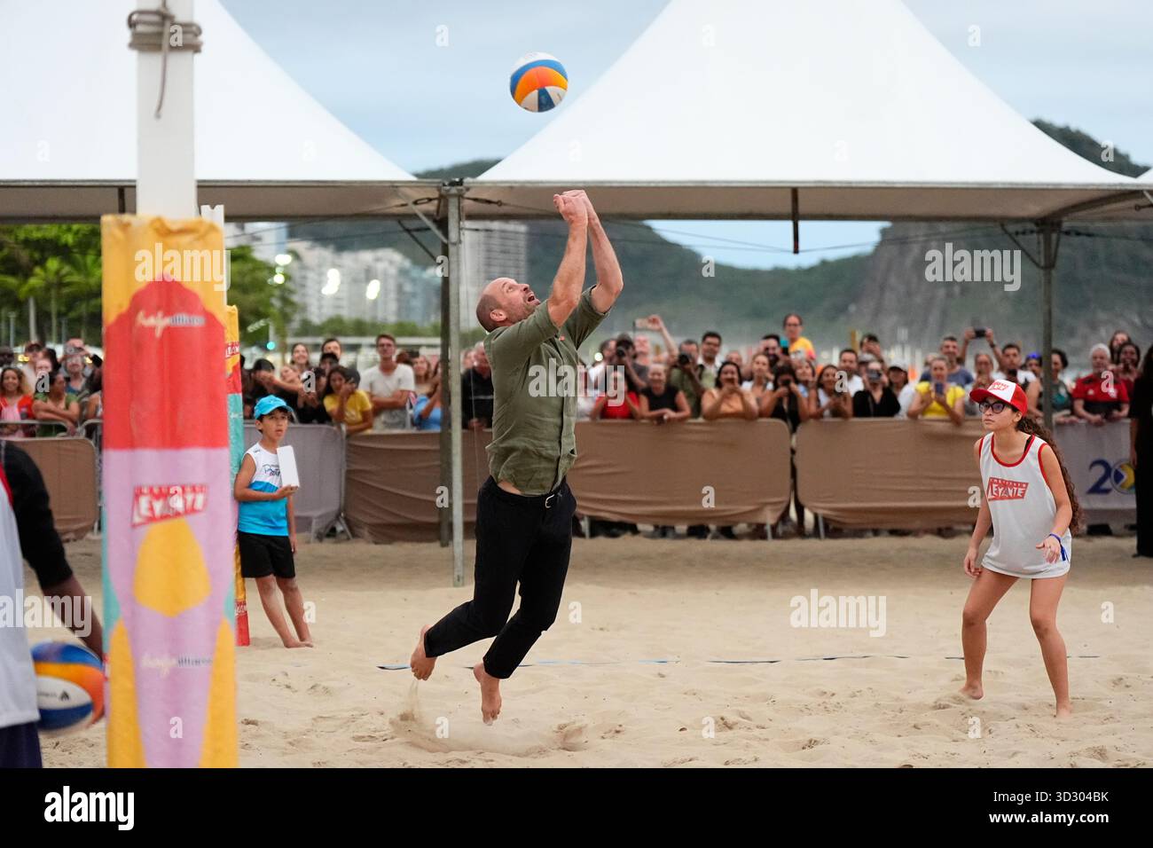 The Prince of Wales takes part in a game of volleyball with players ...