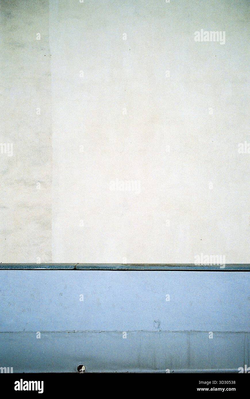 Ochre wall facing a concrete terrace railing, captured in analog film ...
