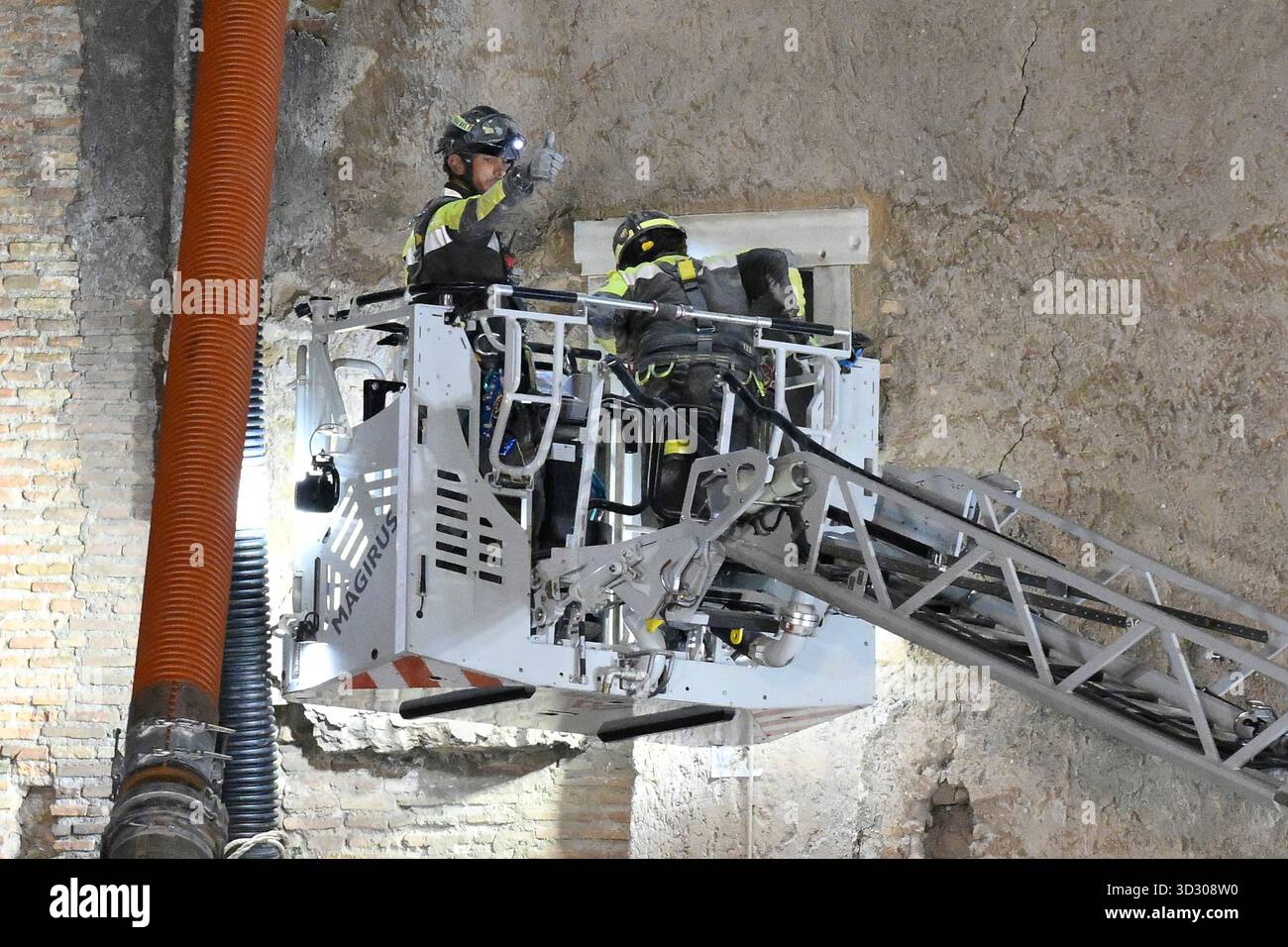 A firefighter gives a thumbs-up as rescuers pull a construction worker ...