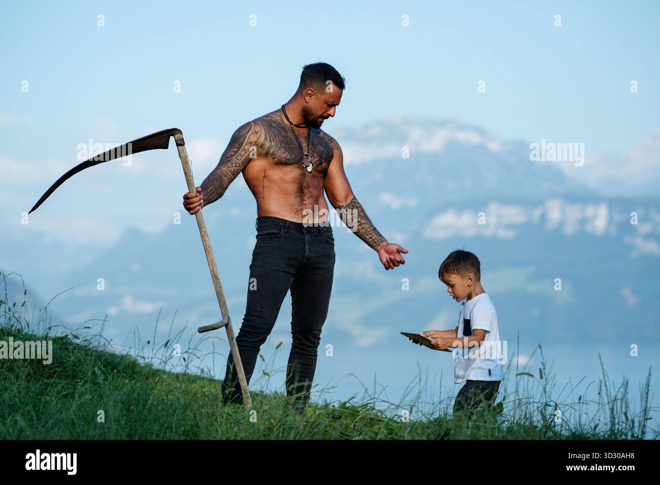 Farmers father and his son work together on farm field. The father ...