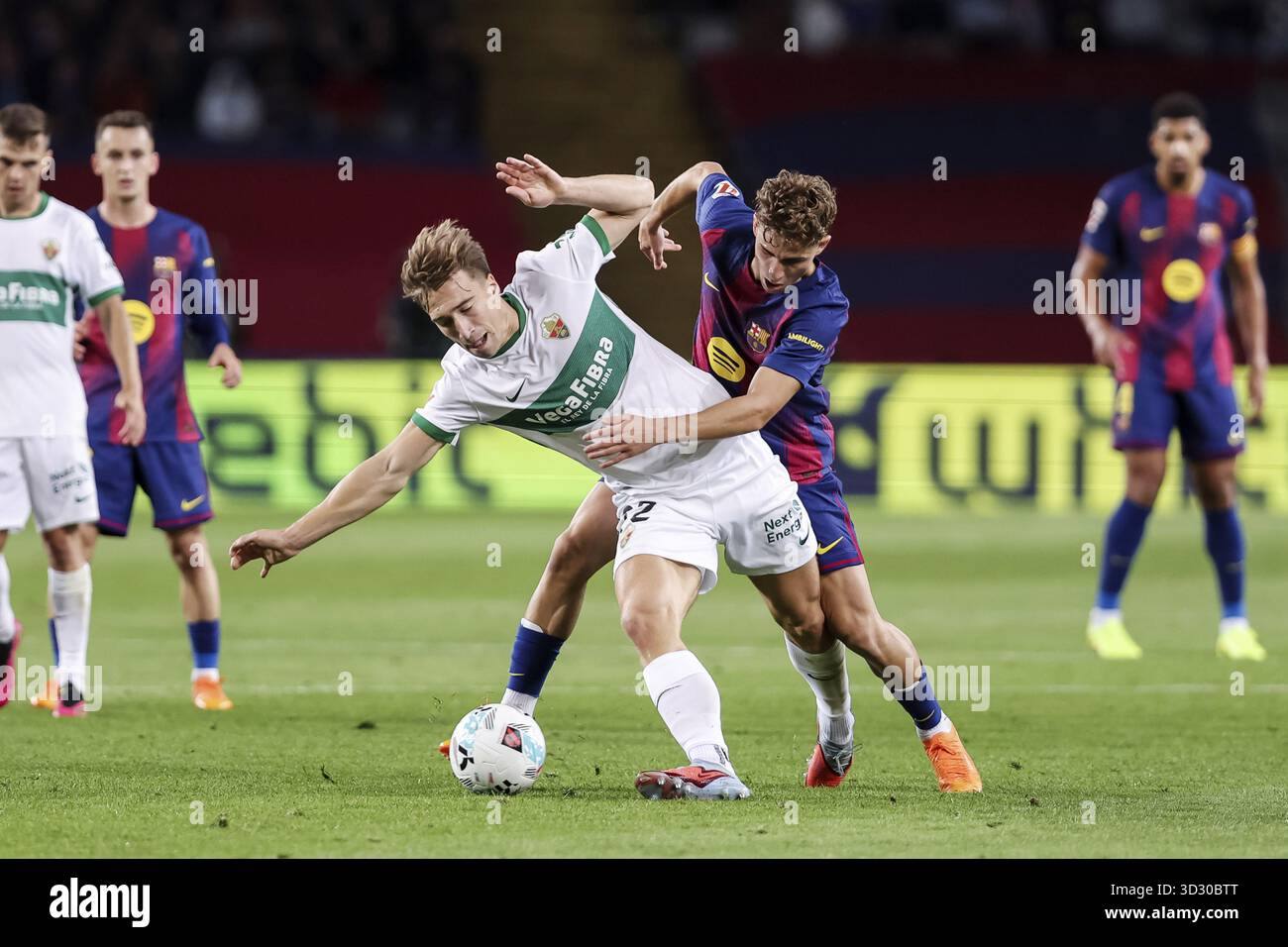 David Affengruber of Elche CF and Fermin Lopez of FC Barcelona during ...