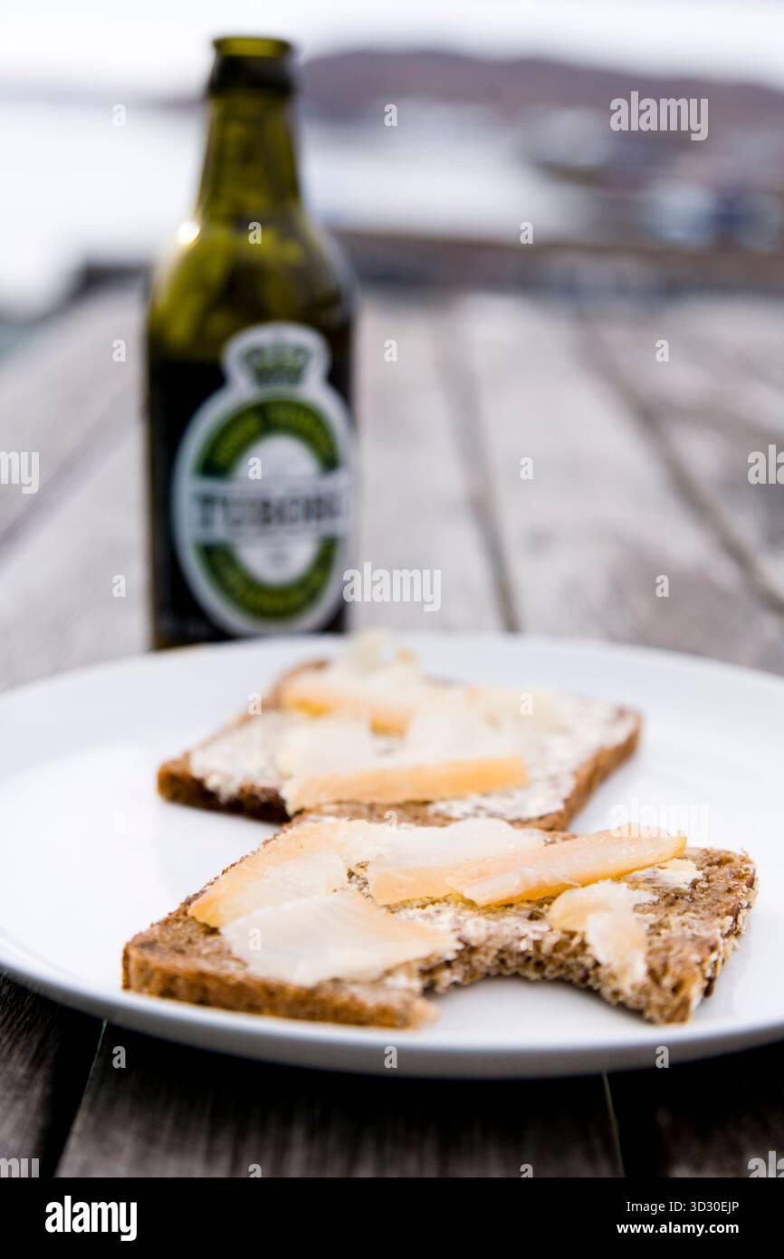 Bread with smoked halibut, Tuborg beer in a bottle. Narsaq, South ...