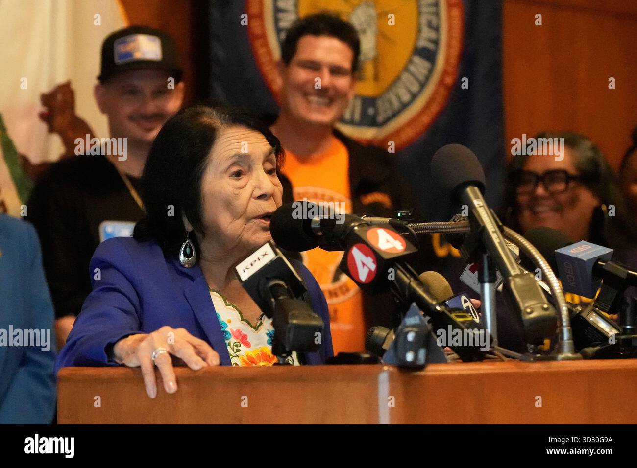 Dolores Huerta, co-founder of United Farm Workers, foreground, speaks ...