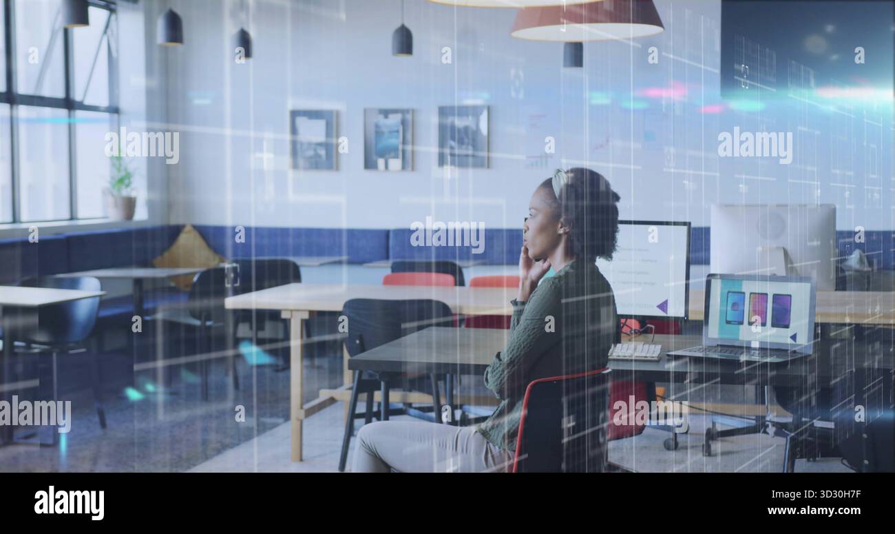 Analyzing woman holding smartphone viewing chart on monitor at open ...