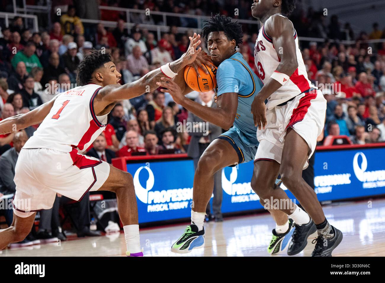 Quinnipiac forward Keith McKnight (21) pushes past St. John's ...