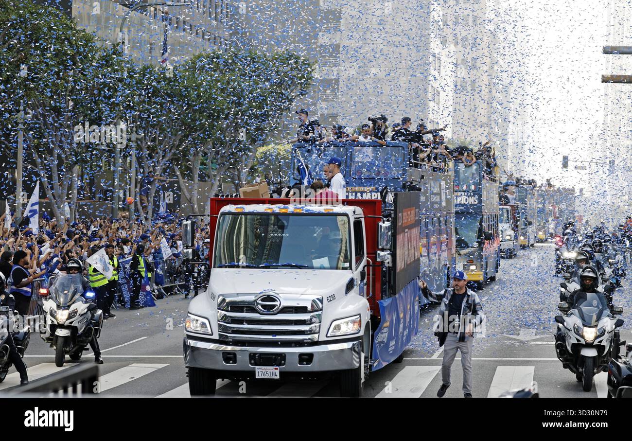 Los Angeles Dodgers players wave from open-top buses during a parade to ...