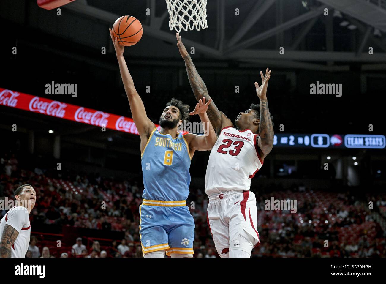 Southern forward Malek Abdelgowad (8) drives past Arkansas forward Nick ...