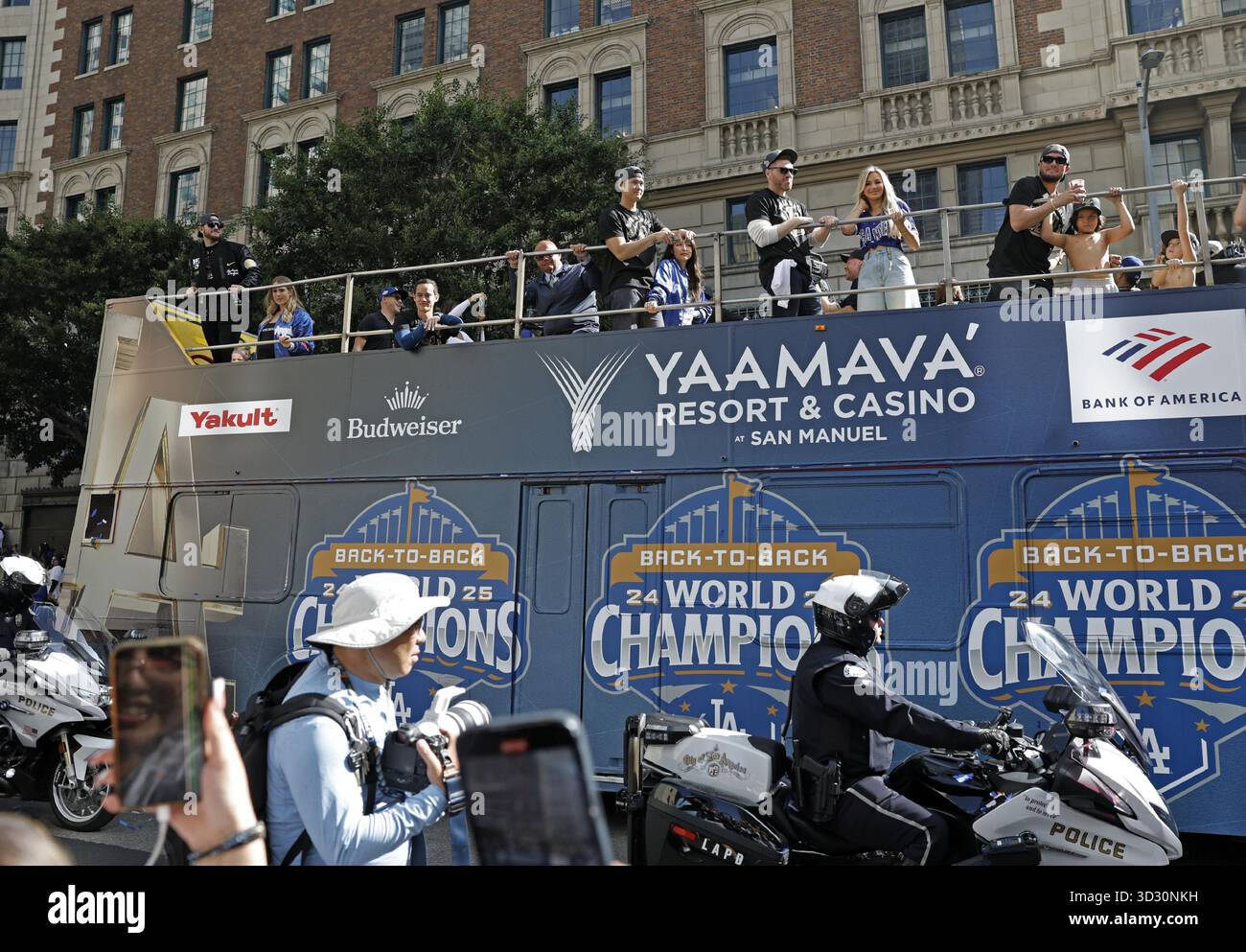 Los Angeles Dodgers players ride on an open-top bus during a parade to ...