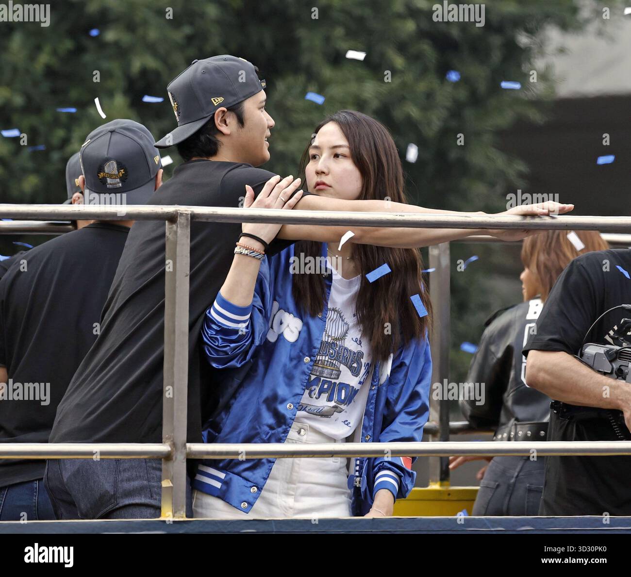 Los Angeles Dodgers two-way player Shohei Ohtani and his wife Mamiko ride on an open-top bus ...