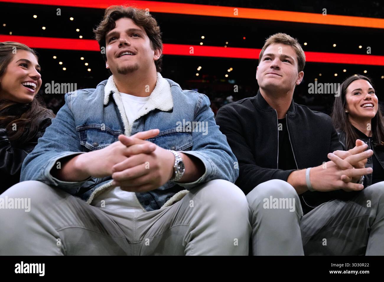 New England Patriots quarterback Drake Maye, center right, sits with ...