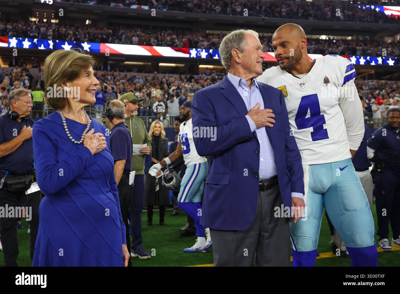 Dallas Cowboys quarterback Dak Prescott (4) talks with former president ...