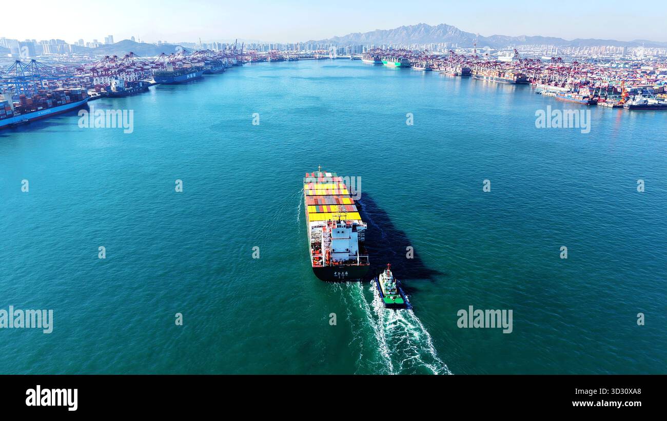 A container ship sails into the harbor in Qingdao in east China's ...