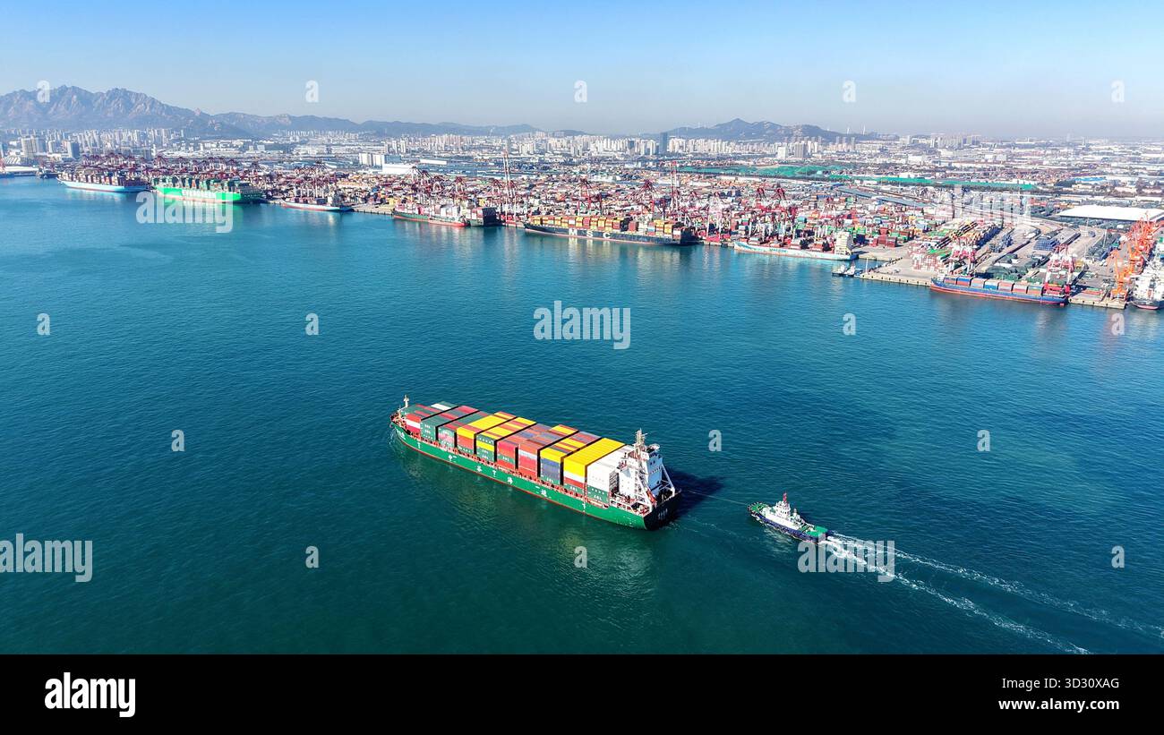A container ship sails into the harbor in Qingdao in east China's ...