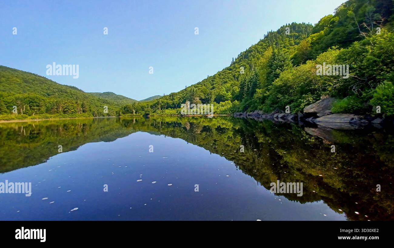 View at the Jacques Cartier lake in Quebec with reflects in the clear ...