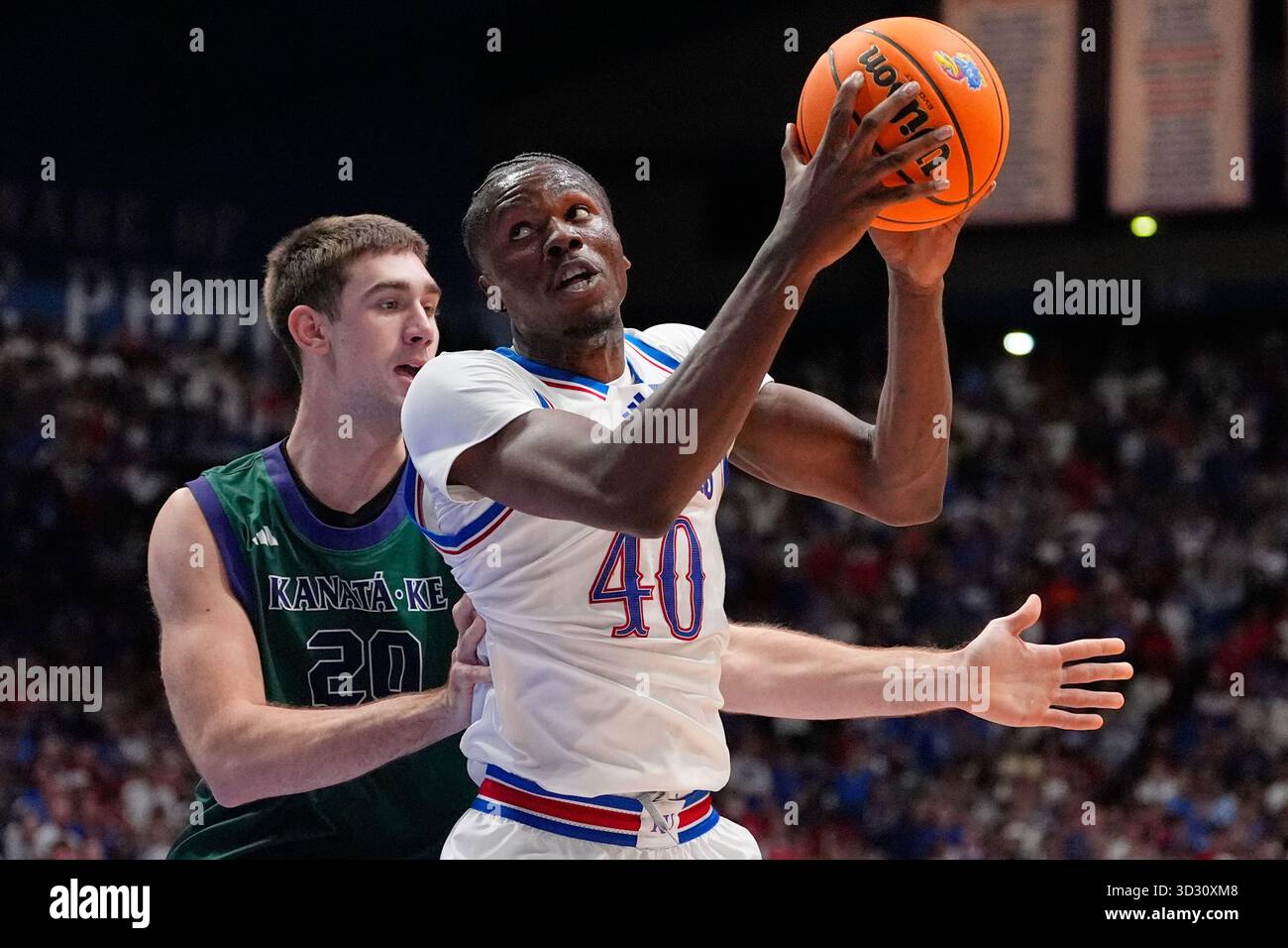 Kansas forward Flory Bidunga (40) looks to shoot under pressure from ...