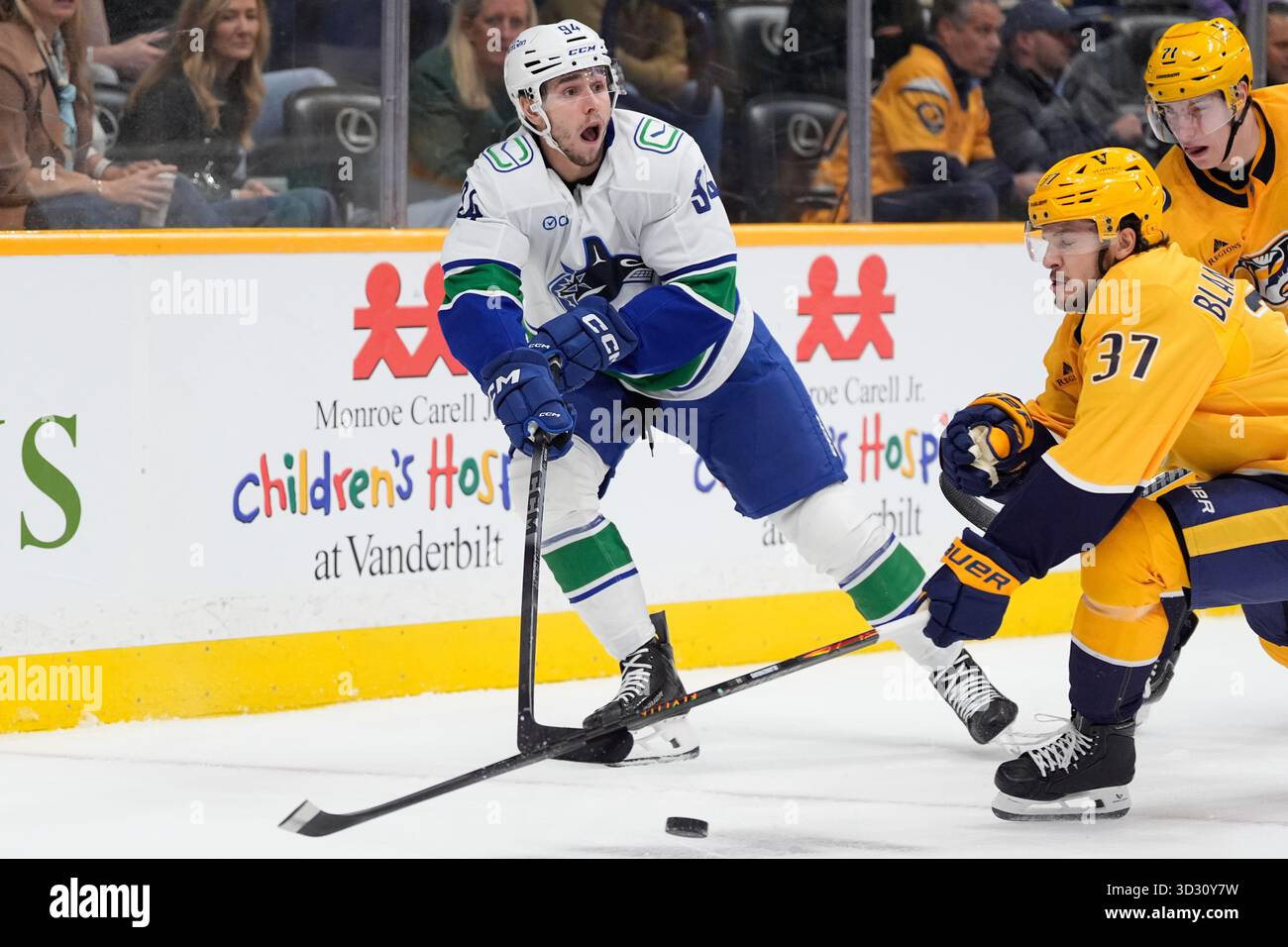 Vancouver Canucks center Linus Karlsson (94) passes the puck around ...