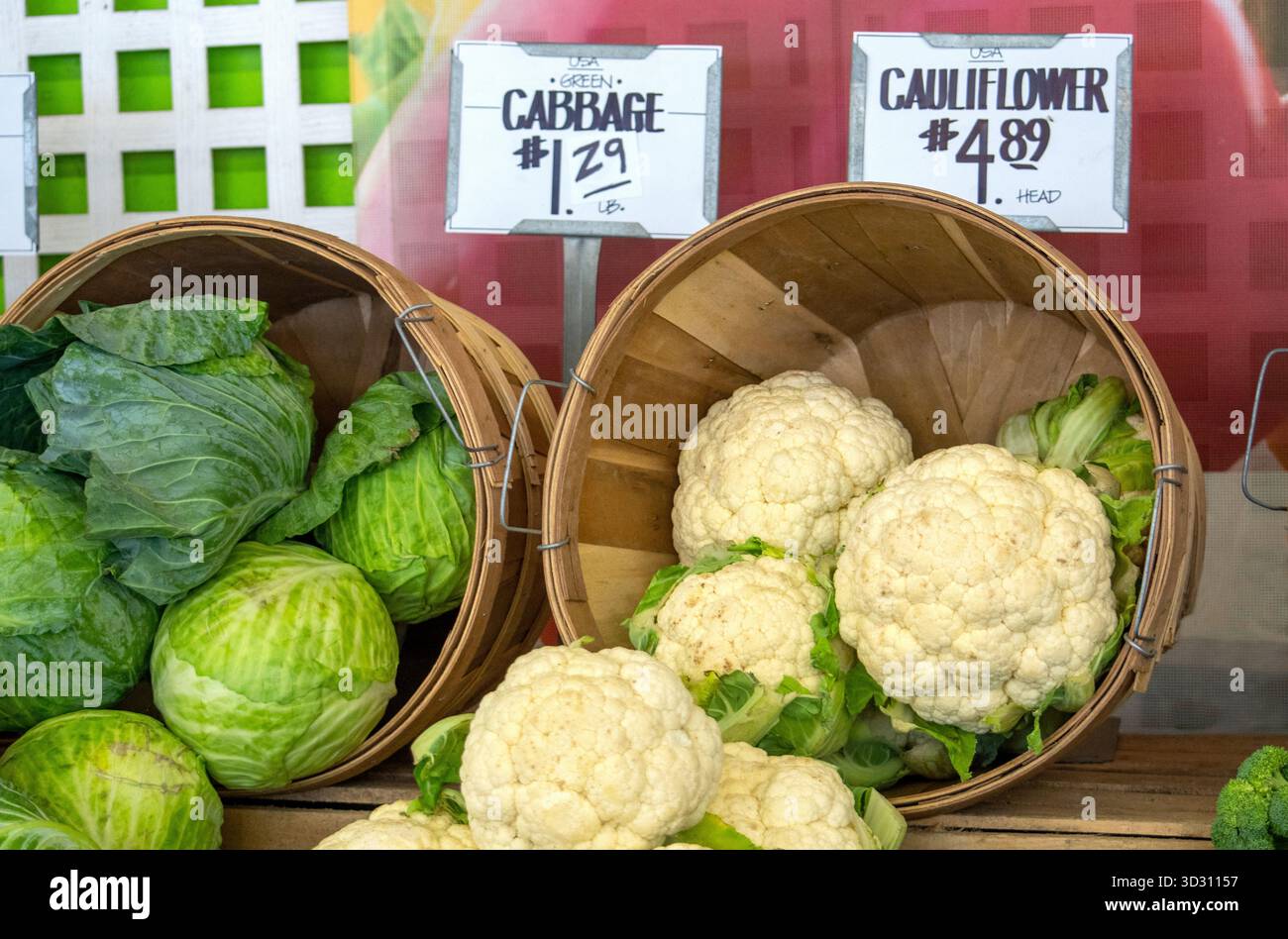baskets of cabbage and cauliflower on display at a farm market Stock ...