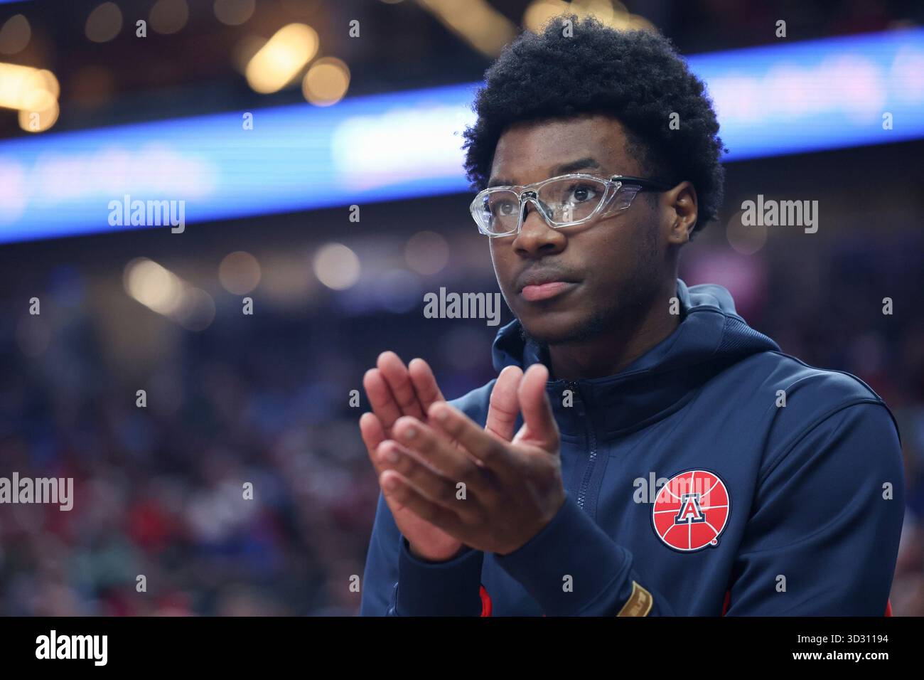 Arizona guard Bryce James claps while sitting on the bench during the ...