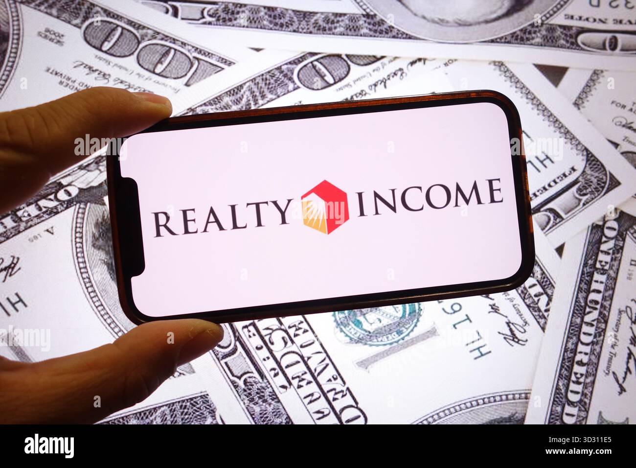In this photo illustration, the Realty Income company logo is seen ...