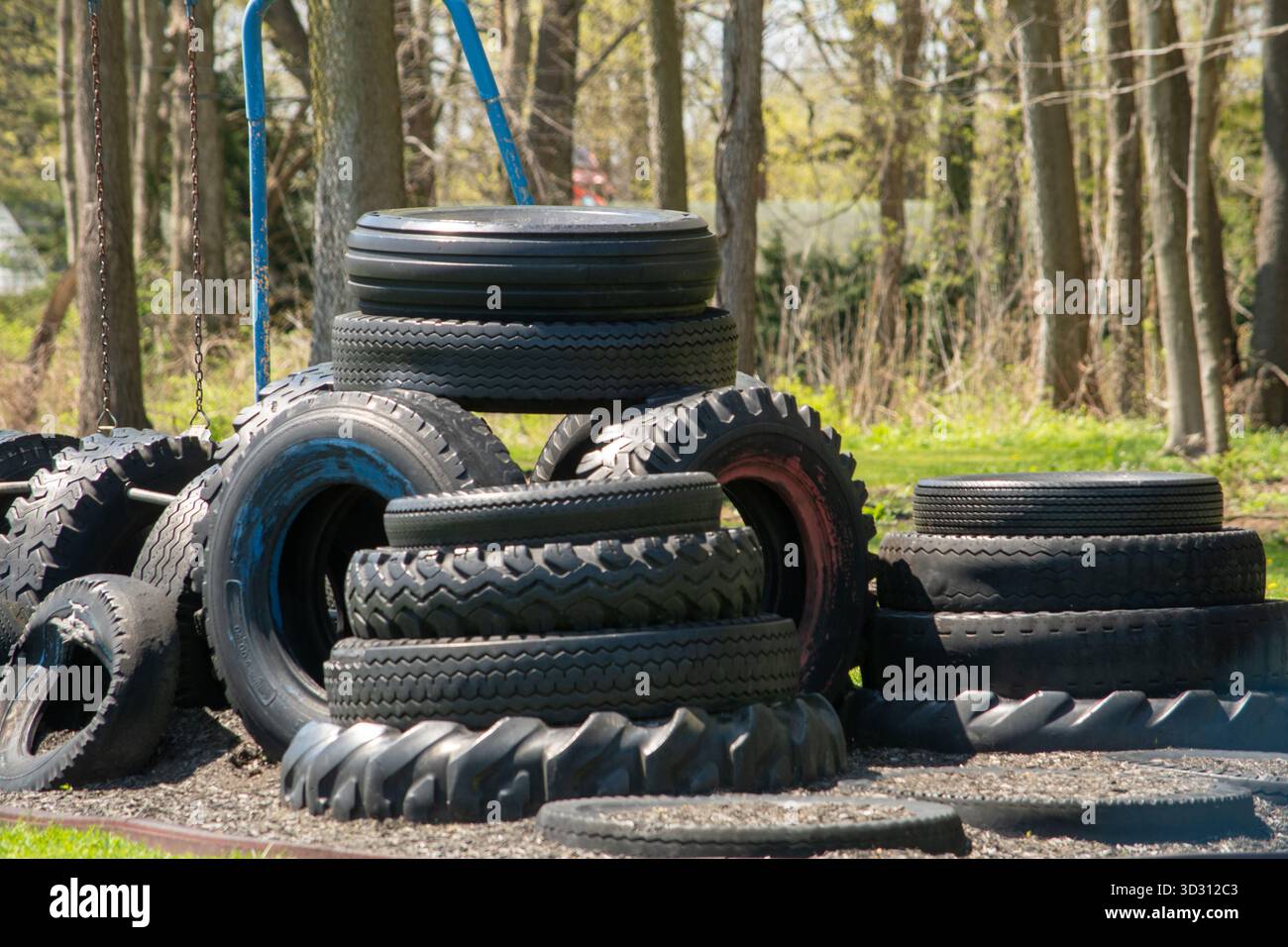A large tire tower on a child play ground provides hours of exercise ...