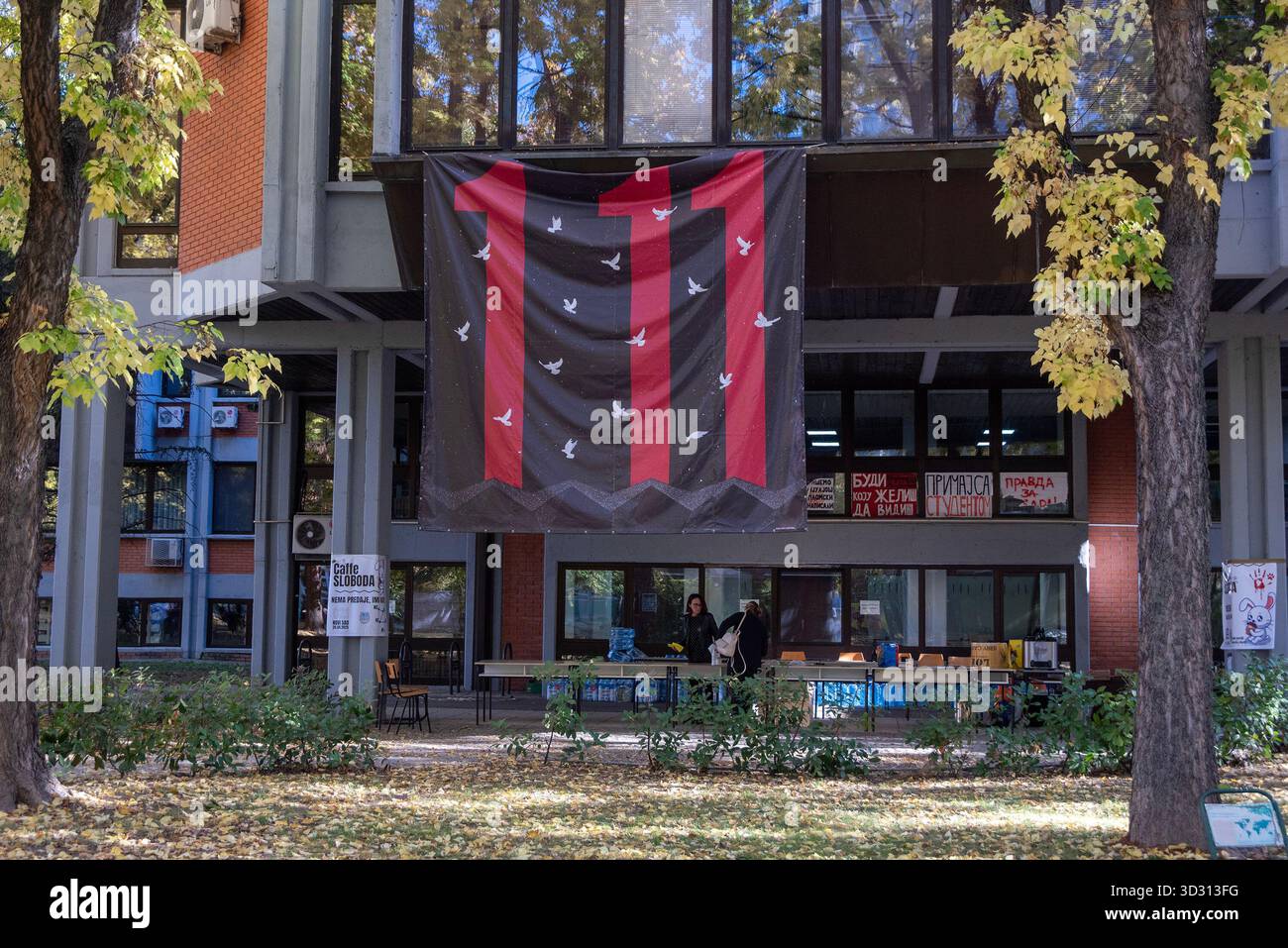 A banner hangs on the campus building before the commemoration ceremony ...