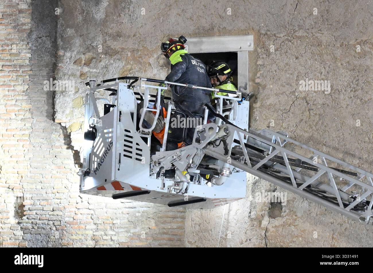Firefighters pull a construction worker from under the debris of a ...