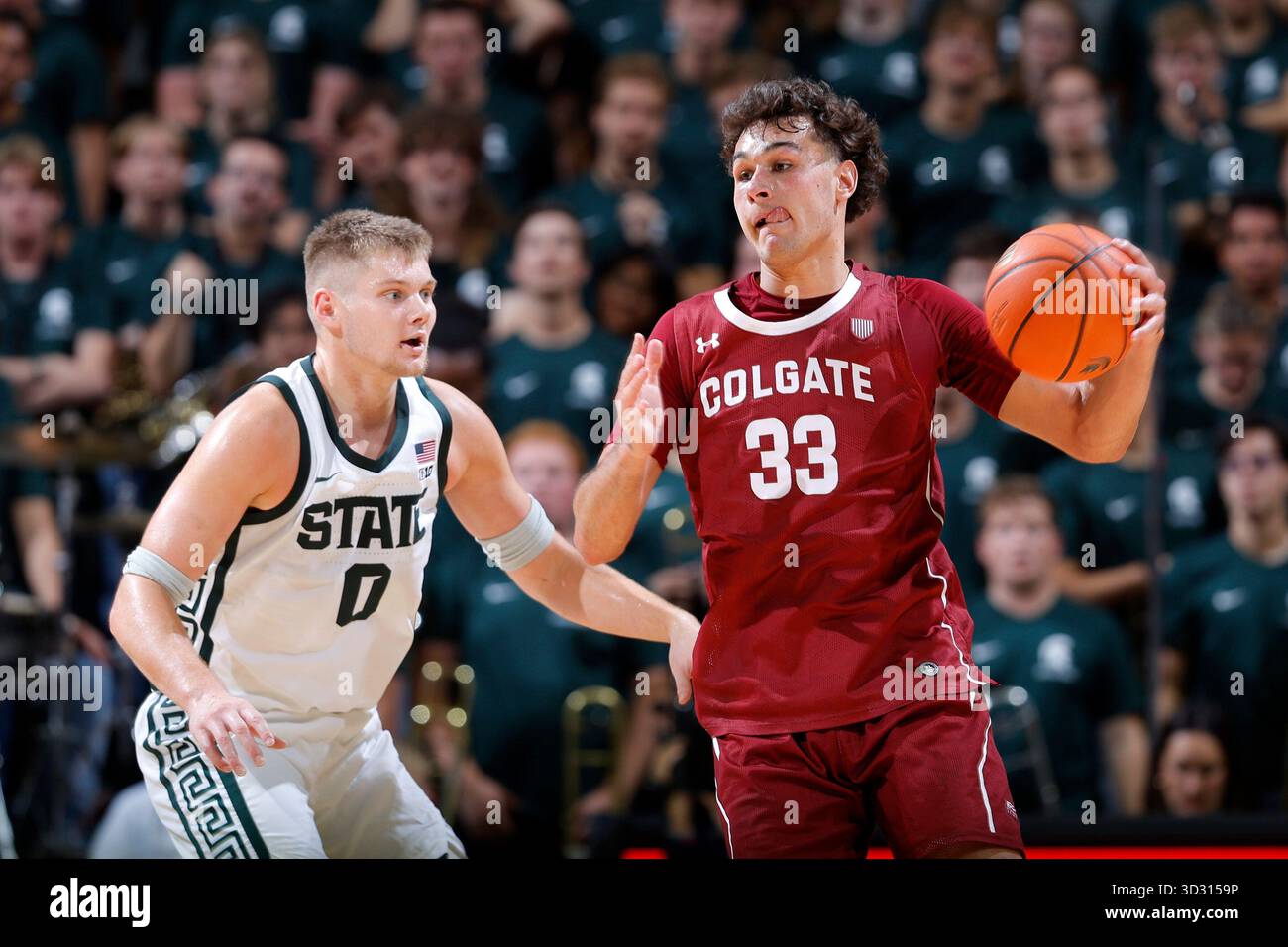 Colgate forward Sam Wright (33), right, maneuvers against Michigan ...