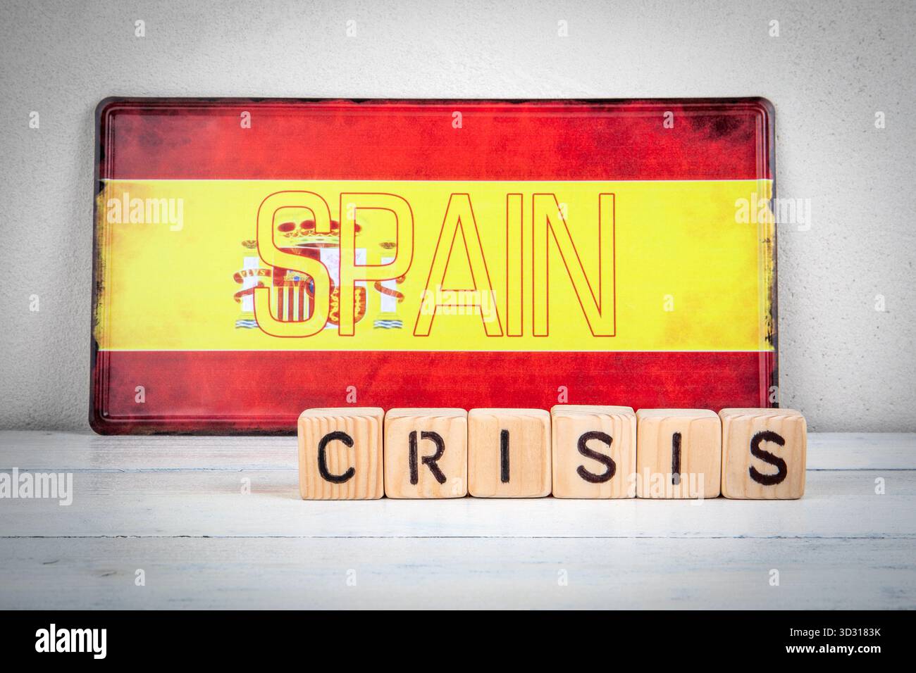 Spanish flag with wooden blocks spelling CRISIS, representing economy ...