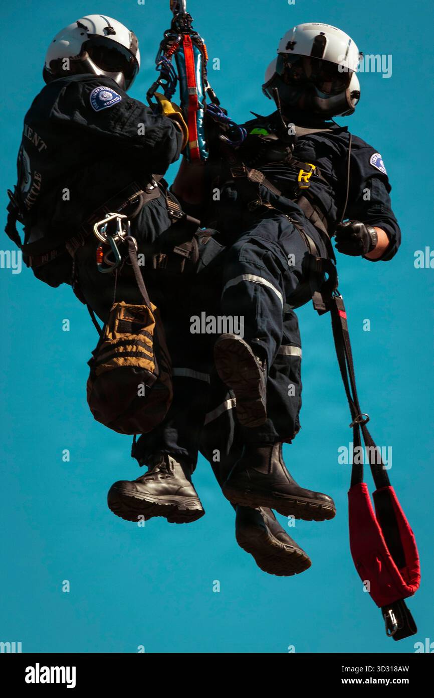 Fire fighters with the Seattle Fire Department rescue team are lifted ...