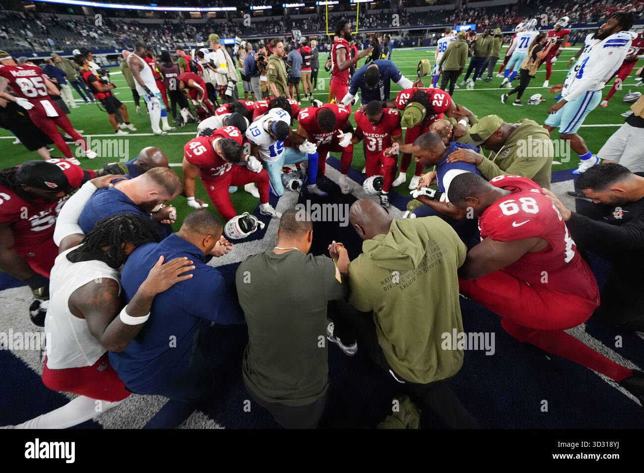 Arizona Cardinals and Dallas Cowboys players and staff pray on the ...