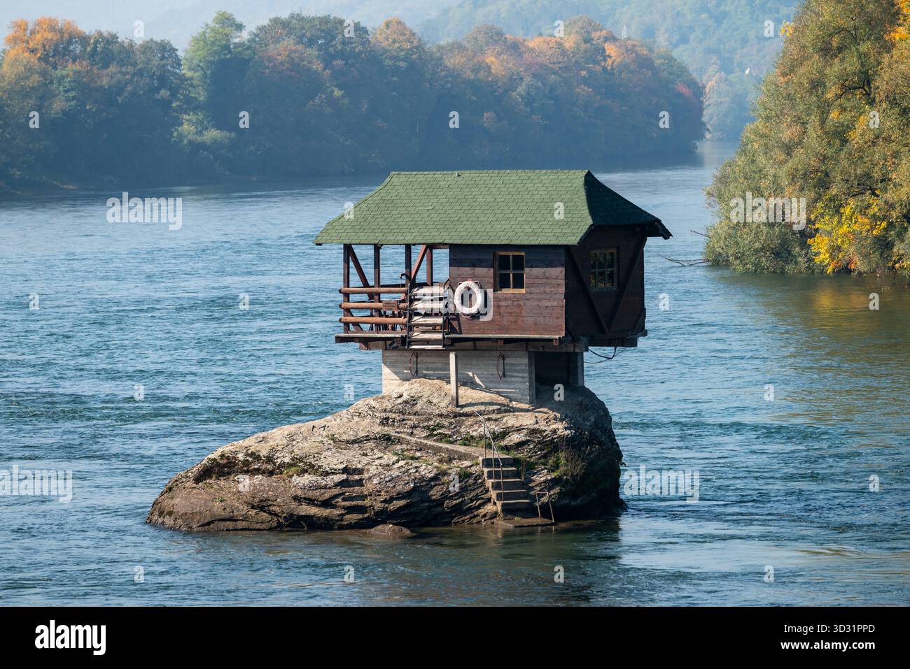 The famous cabin on a rock in the Drina river at Bajina Basta in Serbia with autumn colours ...