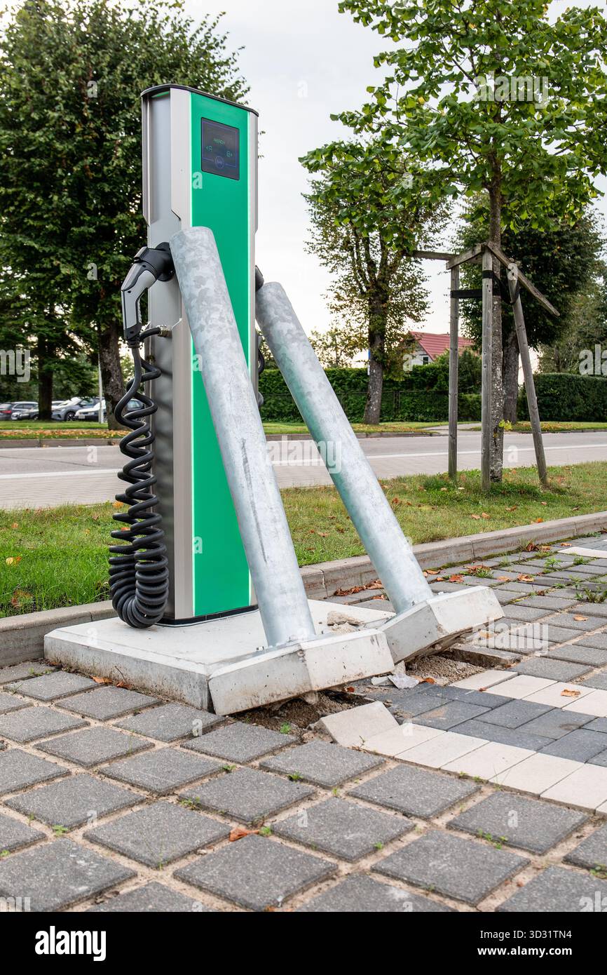 Broken and bent metal safety posts in front of an electric vehicle ...