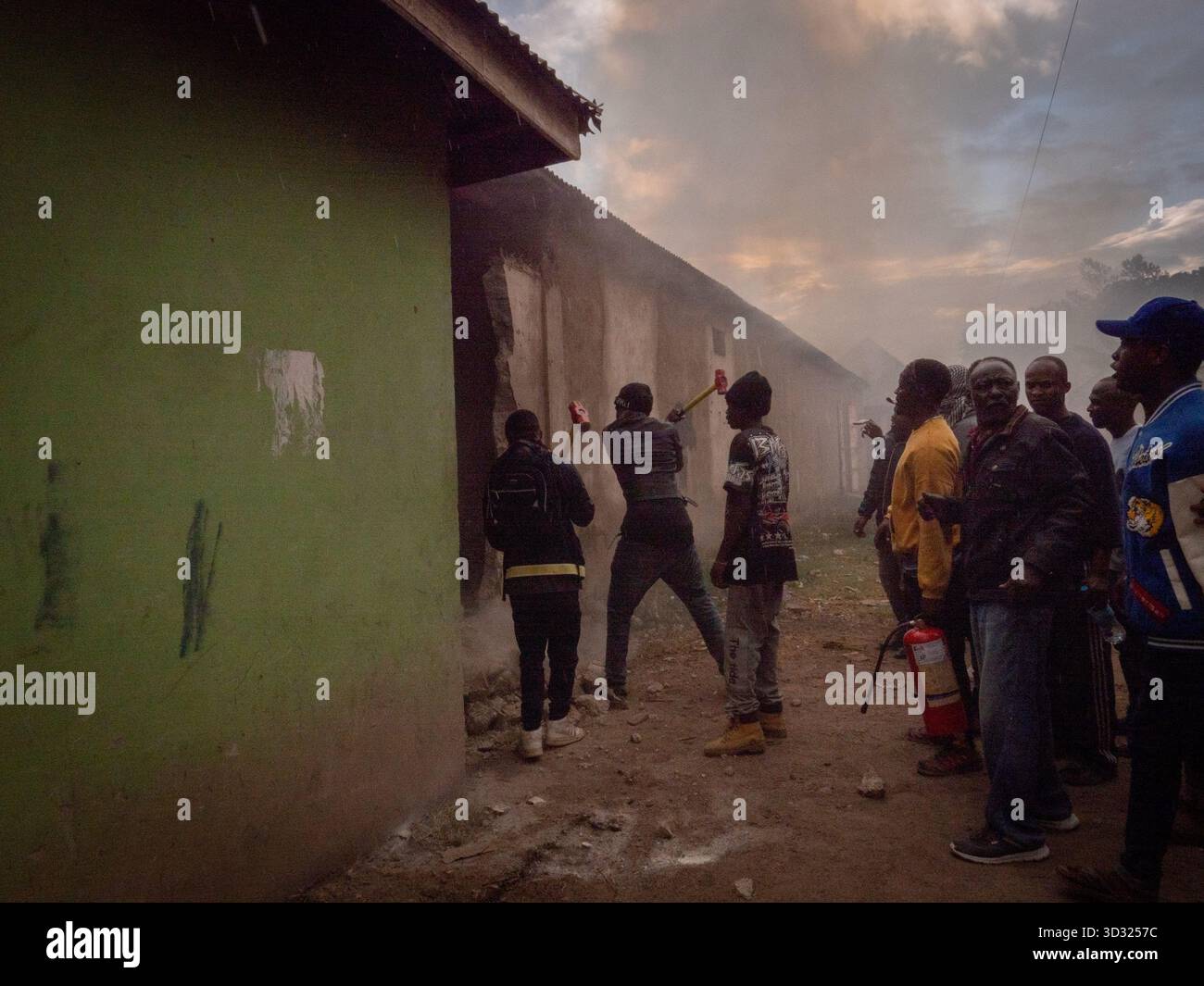 People demolish a structure during protests in Arusha, Tanzania, on ...