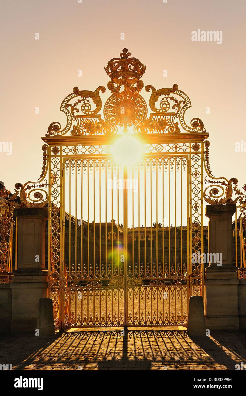 Versailles, France - 04 November 2025: View of the radiant golden gates ...