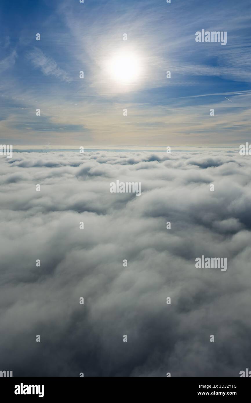 Aerial drone view of industrial chimneys emitting steam above thick fog ...