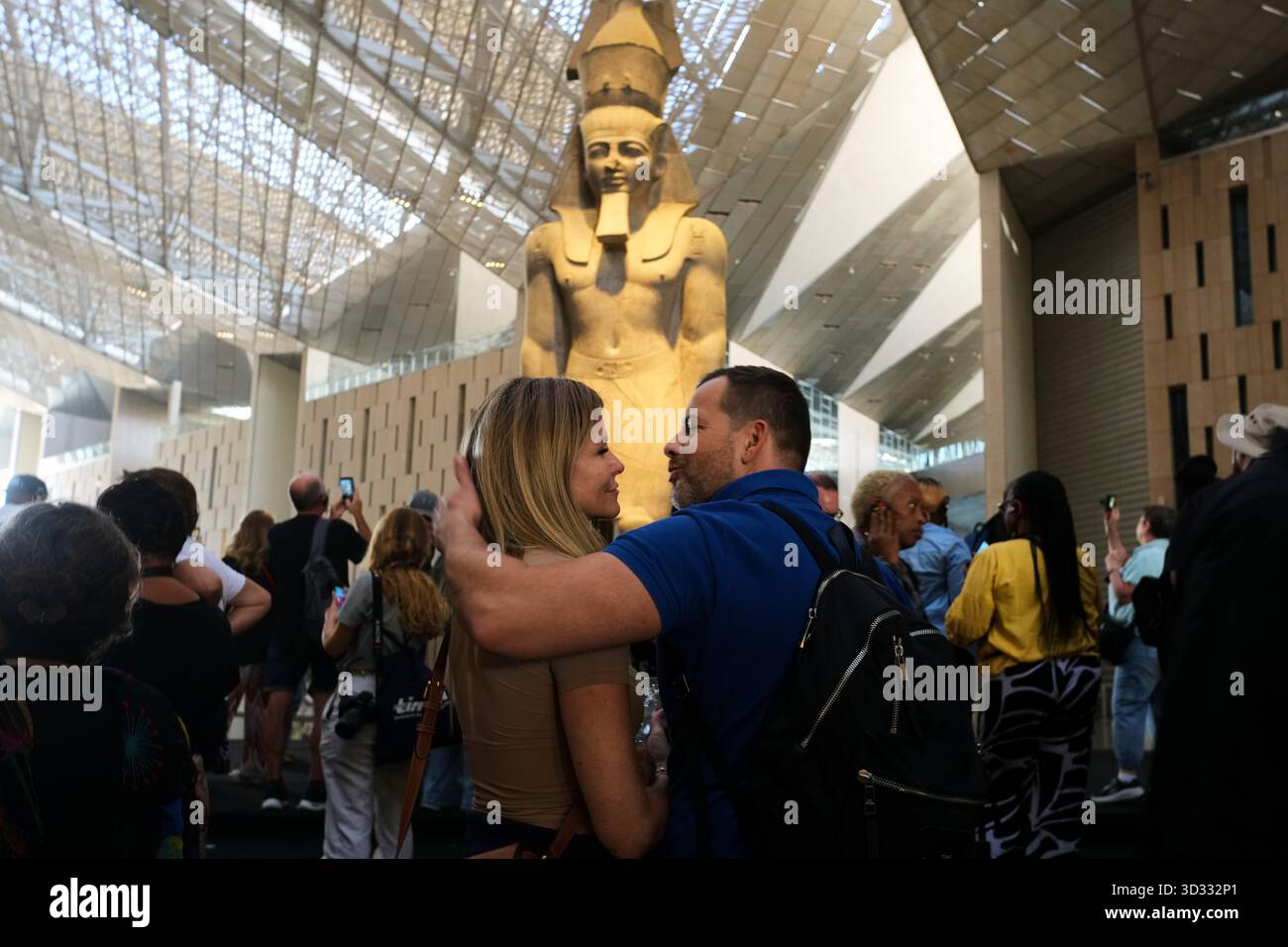 Visitors from Hungary hug each other in front of the statue of Pharaoh ...