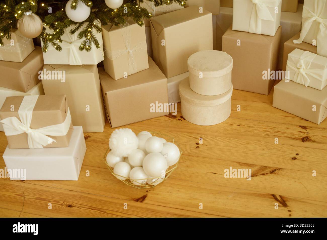 close-up of wrapped Christmas gifts lying on the floor under the ...