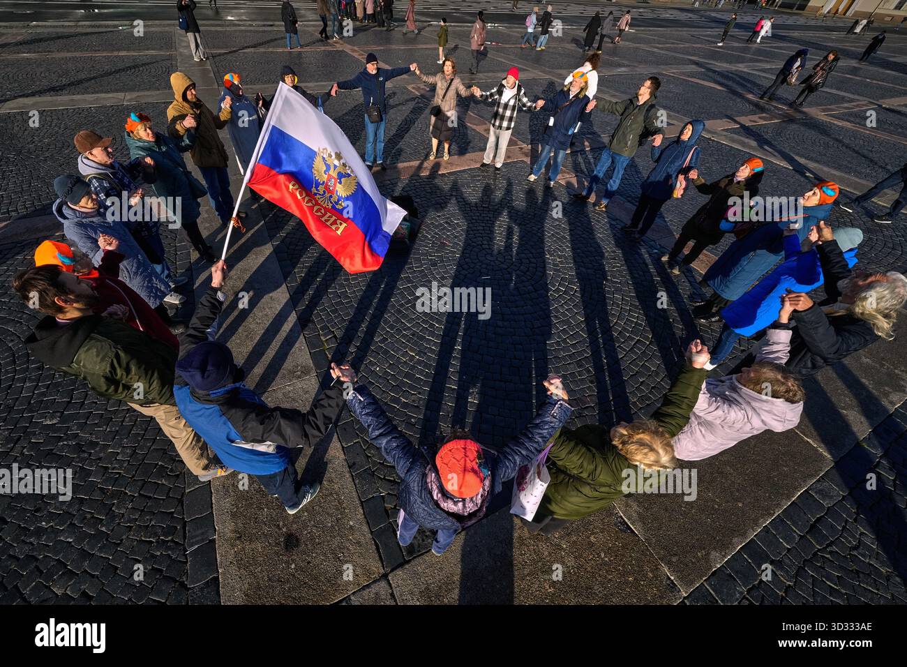 People dance in a circle marking a National Unity Day at the Palace ...
