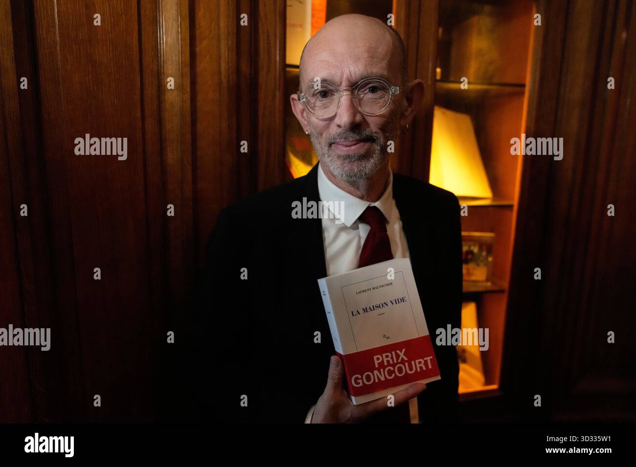 French novelist Laurent Mauvignier holds his book "La Maison Vide" (The ...